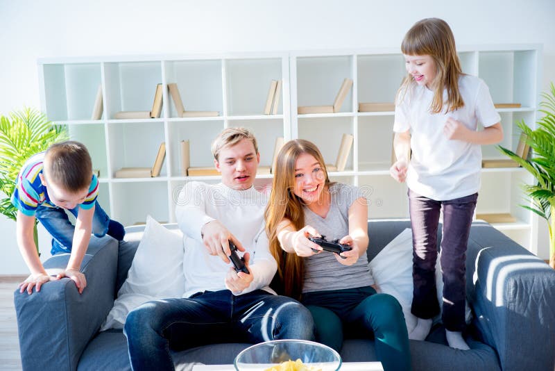 Family playing video games stock photo. Image of house - 90365262