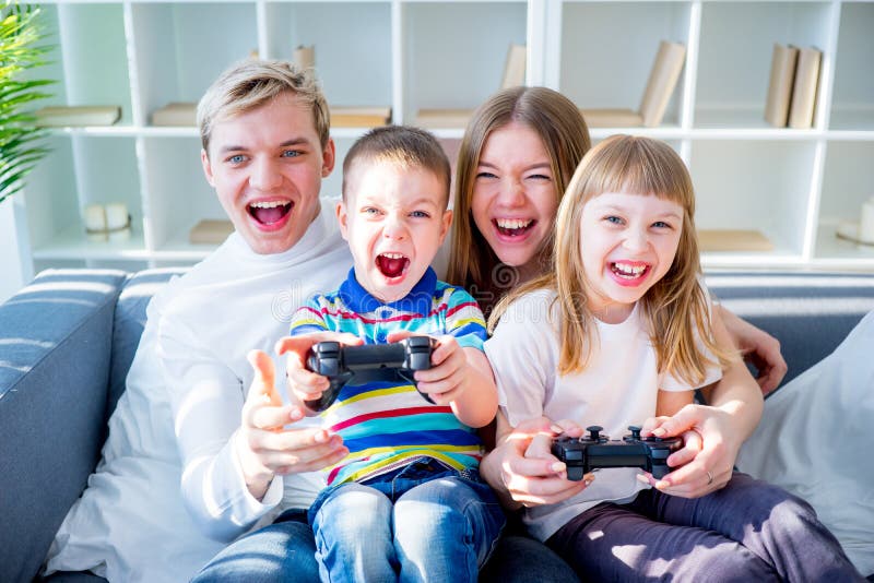 Family playing video games stock image. Image of enjoyment - 90365321