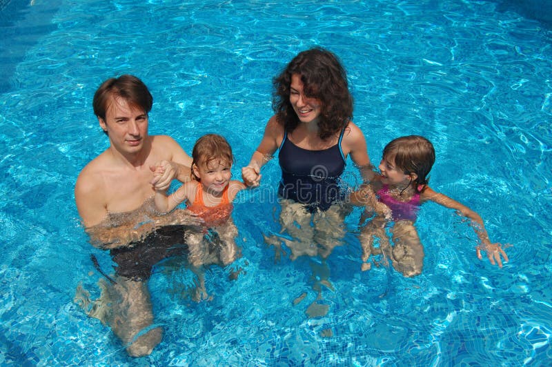 Family in the pool stock image. Image of joyful, four - 10311067