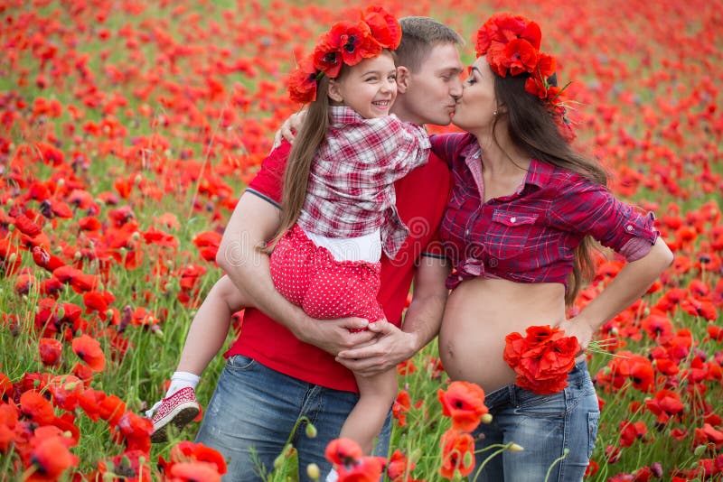 Family on the poppy field stock photo. Image of grass - 62101526