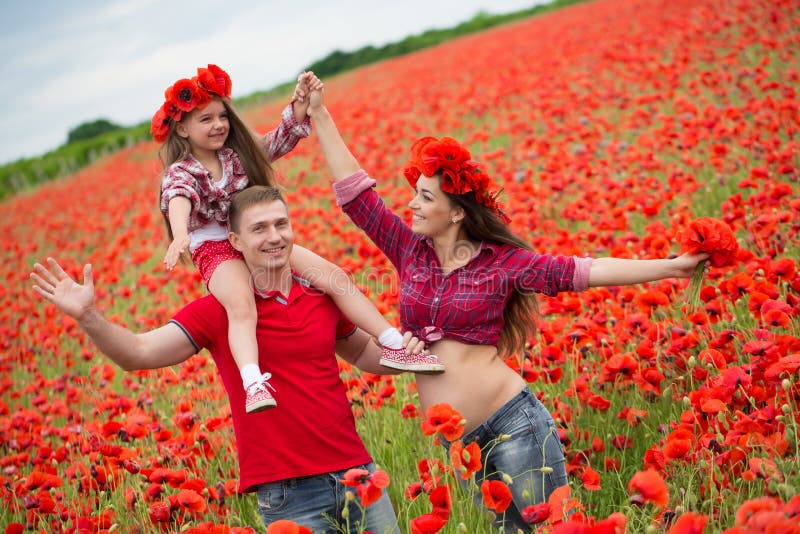 Family on the poppy meadow stock photo. Image of animal - 31320290