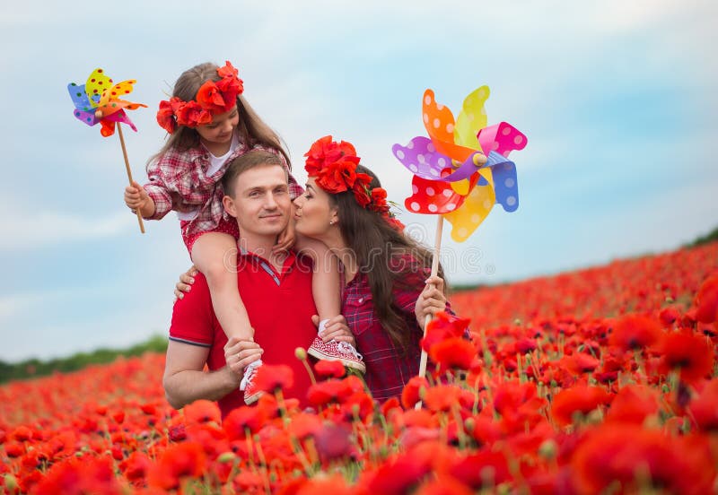 Family on the poppy field stock photo. Image of loving - 62101536