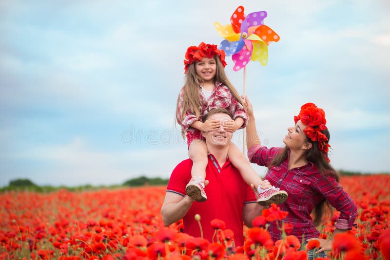 Family on the poppy field stock image. Image of outside - 62101637