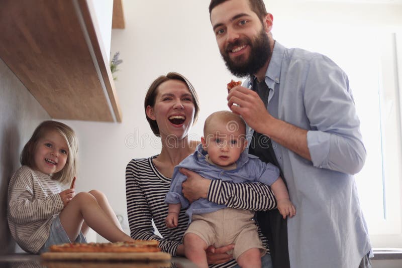Family of 4 Posing in the Kitchen Smiling and Happy Stock Image - Image ...