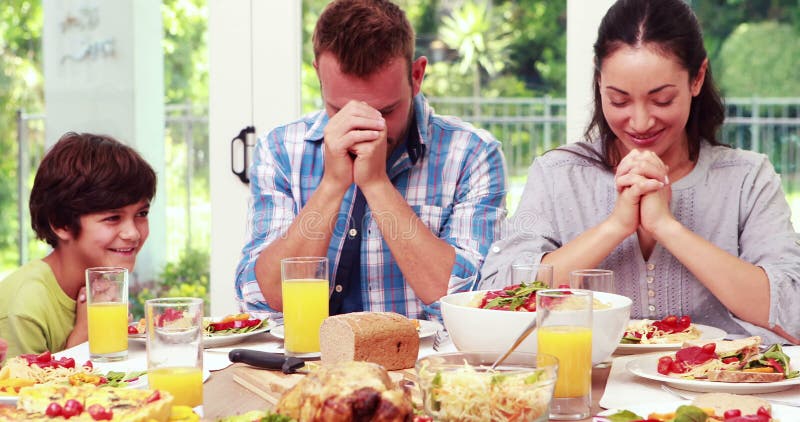 Family, Praying and Holding Hands at Lunch for Worship, Gratitude or ...