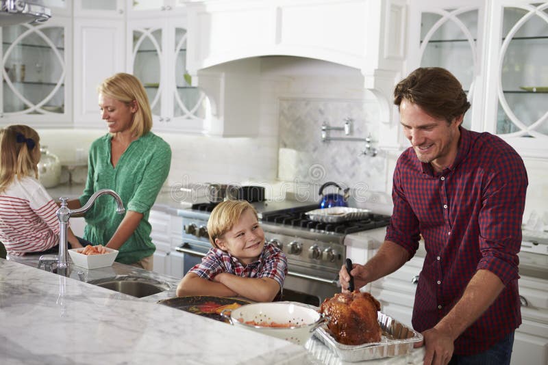 Family Preparing Roast Turkey Meal in Kitchen Together Stock Photo ...