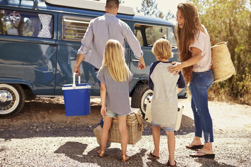 Family Preparing Their Camper Van for a Road Trip, Back View Stock ...