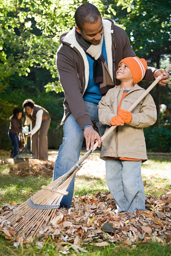 Family raking leaves stock photo. Image of help, adorable - 62534006