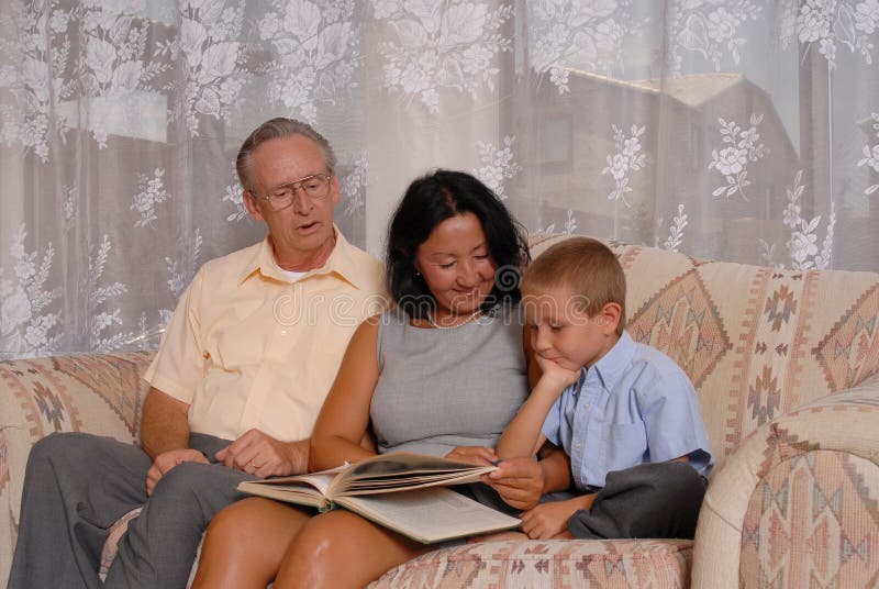 Family reading a story stock image. Image of home, sister - 1550737