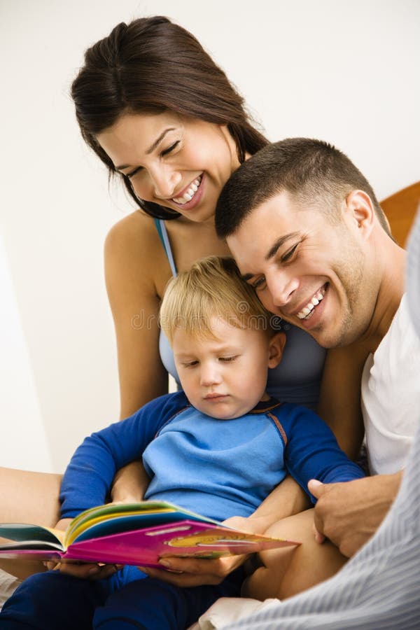 Family reading book. stock image. Image of brunette, parent - 3423605