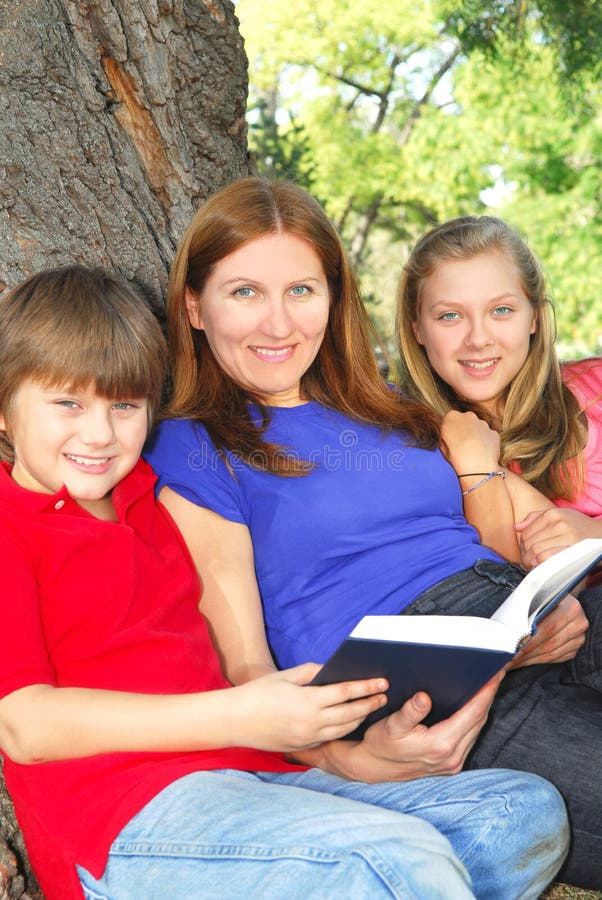 Family reading a book stock image. Image of happy, parent - 3454417