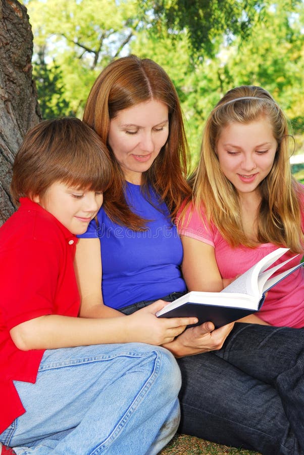 Family reading a book stock photo. Image of childhood - 3454426