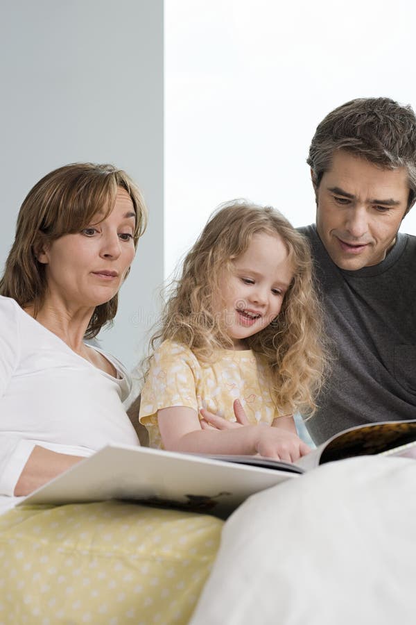 Family reading a book stock image. Image of house, morning - 62806237
