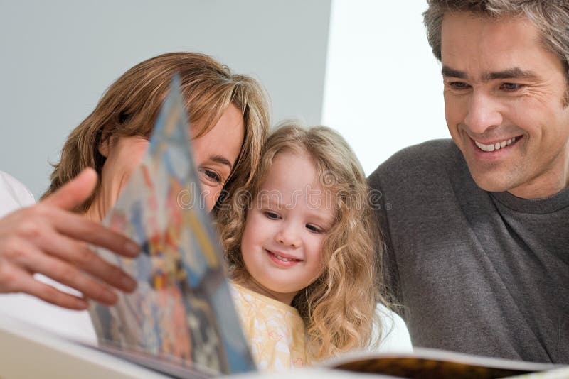 Family reading a book stock photo. Image of innocent - 62806346