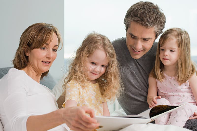 Family reading a book stock photo. Image of girl, indoors - 62806406