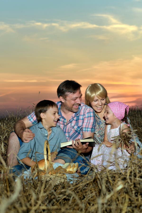 Family Reading Book in Field Stock Photo - Image of mother, male: 55175476