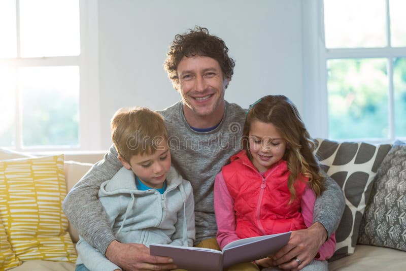 Family reading a book stock photo. Image of girl, female - 78674904