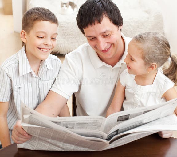 Family reading a newspaper stock photo. Image of newspaper - 22806438