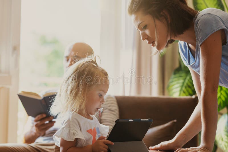 Family Relaxes on Floor, Playing Educational Apps Stock Image - Image ...