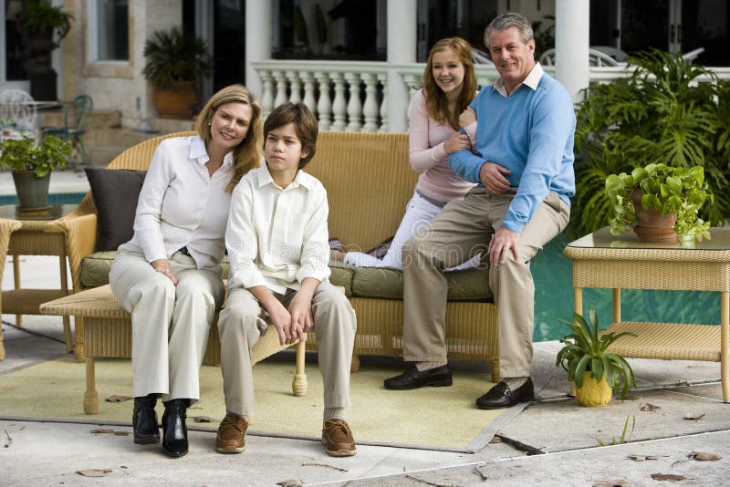 Family relaxing on patio stock image. Image of smile - 10649587