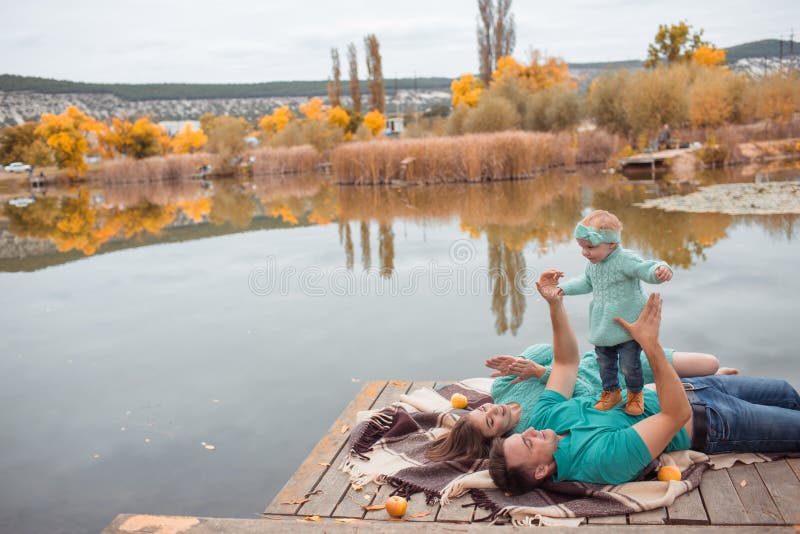 Family resting on the lake stock image. Image of lake - 61936749