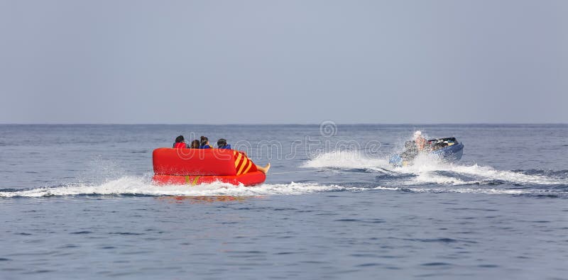 Family Rides on a Red Inflatable Sofa Stock Photo - Image of sofa ...