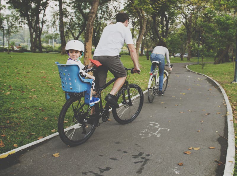 Family Riding Bicycle in the Park on Holiday Concept Stock Photo ...