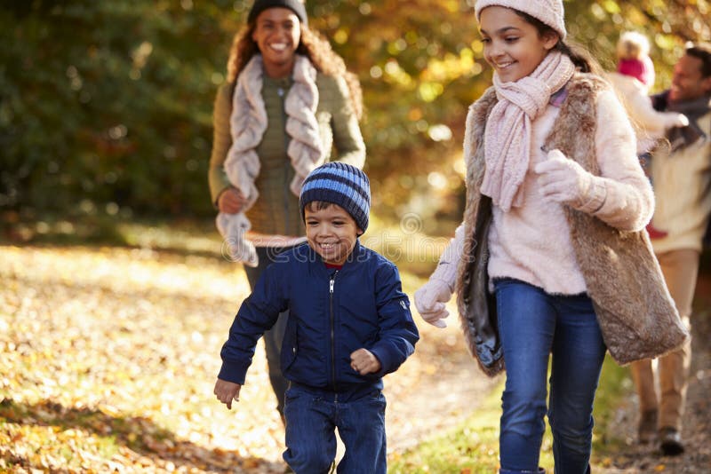 Family Running Along Path through Autumn Countryside Stock Photo ...