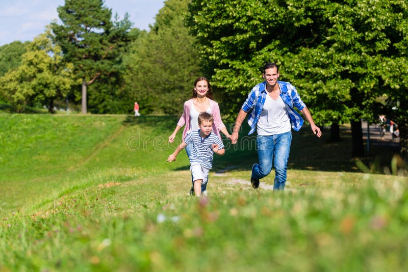 Family Running Fast in Grass on Meadow Stock Photo - Image of blue ...