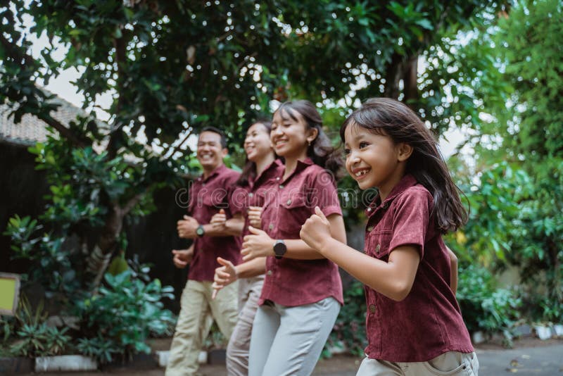 Family Running Outdoors Smiling and Enjoying the Weekend Stock Photo ...