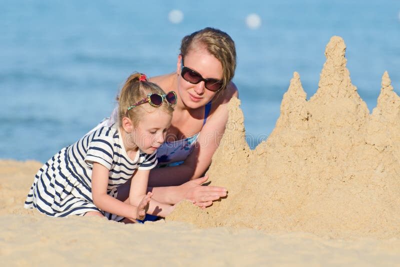Family with sand castle stock image. Image of little - 38858981