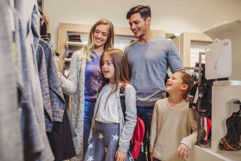 Family Shopping for Clothes at Store Stock Photo - Image of mother ...