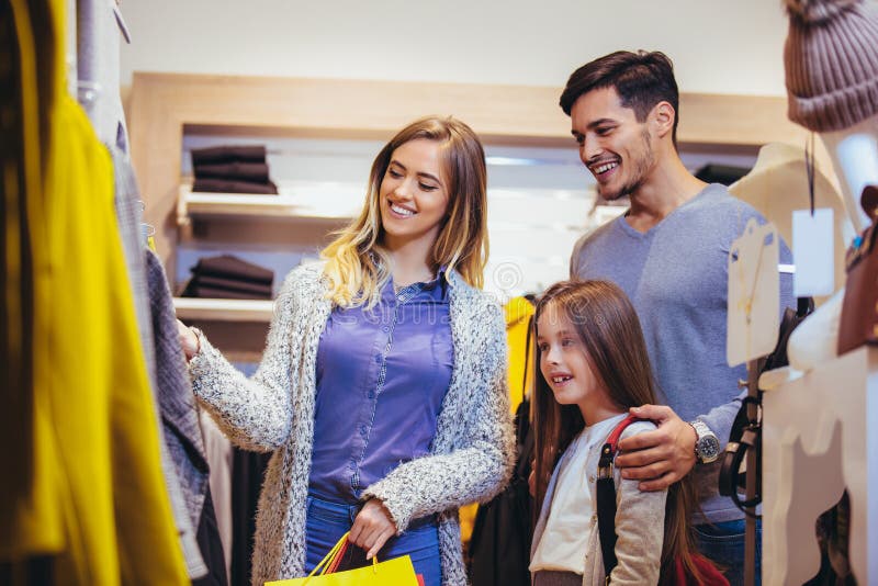 Family Shopping for Clothes at Store Stock Photo - Image of mother ...