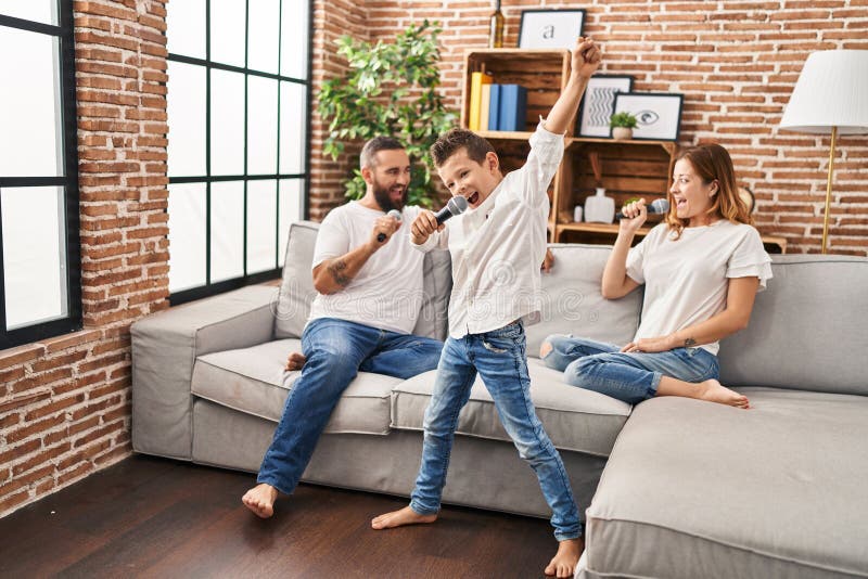 Family Singing Song Using Microphone at Home Stock Photo - Image of ...