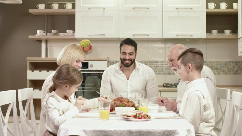 Family Sitting Around a Table, Eating, Communicating and Having Fun ...