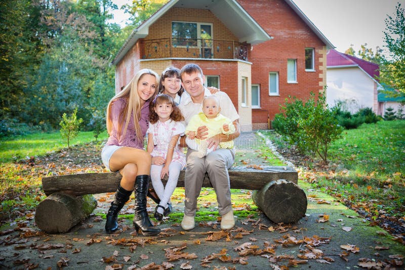 Family Sitting in Backyard of New Home Stock Image - Image of daughter ...