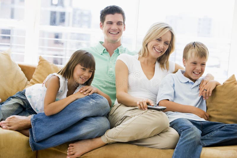 Family Sitting in Living Room with Remote Control Stock Photo - Image ...
