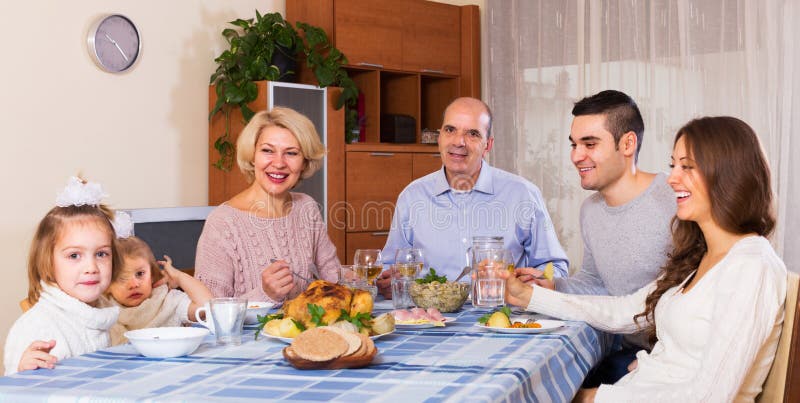 Family Sitting at Table for Dinner Stock Image - Image of little, food ...
