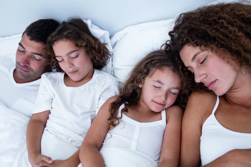 Family Sleeping Together on Bed Stock Photo - Image of child, household ...