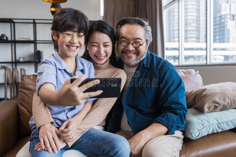 Family Smiling at Camera. Happy Family Taking a Selfie, Smiling at a ...