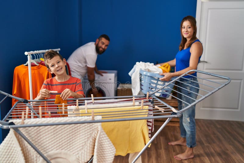 Family Smiling Confident Doing Laundry at Laundry Room Stock Image ...
