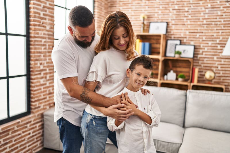 Family Smiling Confident Hugging Each Other Standing at Home Stock ...