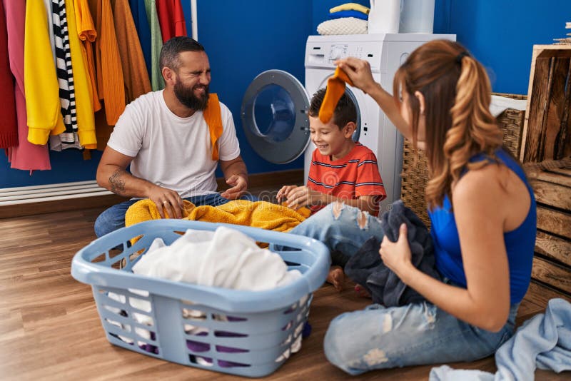 Family Smiling Confident Playing with Clothes at Laundry Room Stock ...