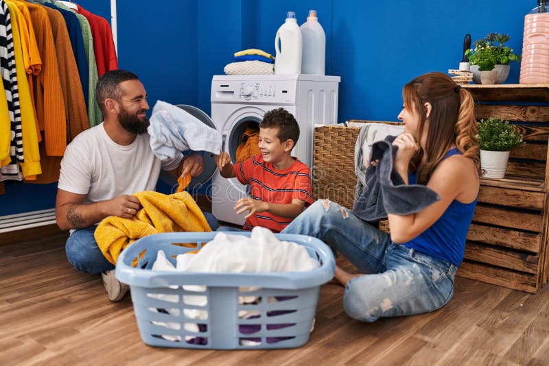 Family Smiling Confident Playing with Clothes at Laundry Room Stock ...