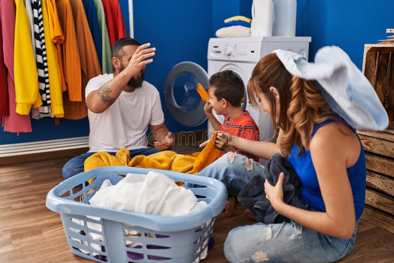 Family Smiling Confident Playing with Clothes at Laundry Room Stock ...