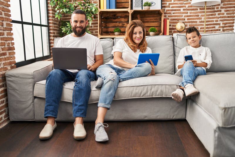Family Smiling Confident Using Technology Device at Home Stock Photo ...