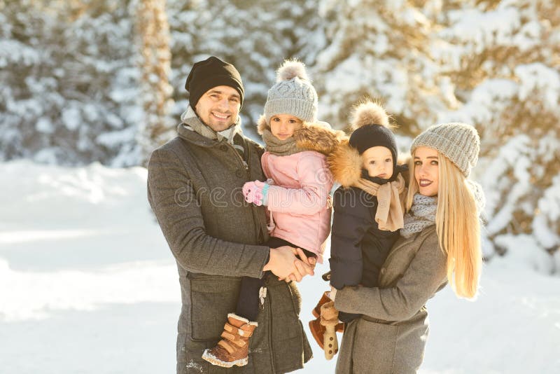 Family Smiling in Winter in a Park Stock Photo - Image of sunset ...
