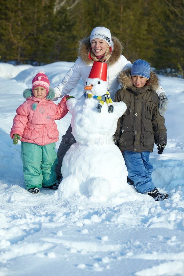 Group of Children Building Snowman on Ski Holiday Stock Image - Image ...