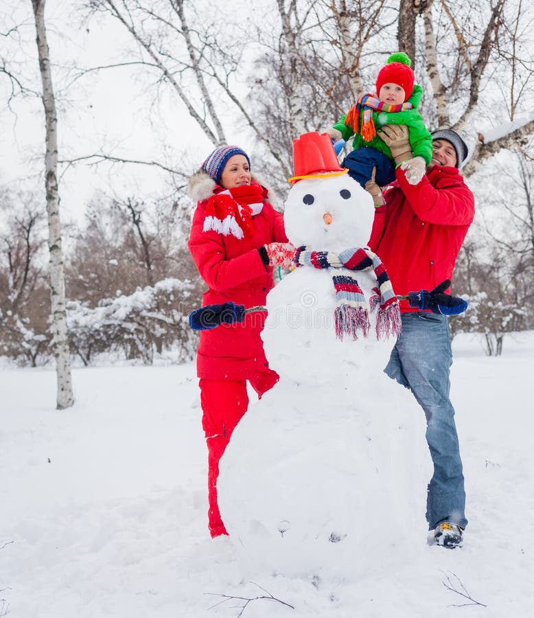 Family with a snowman stock image. Image of outside, happiness - 33445807