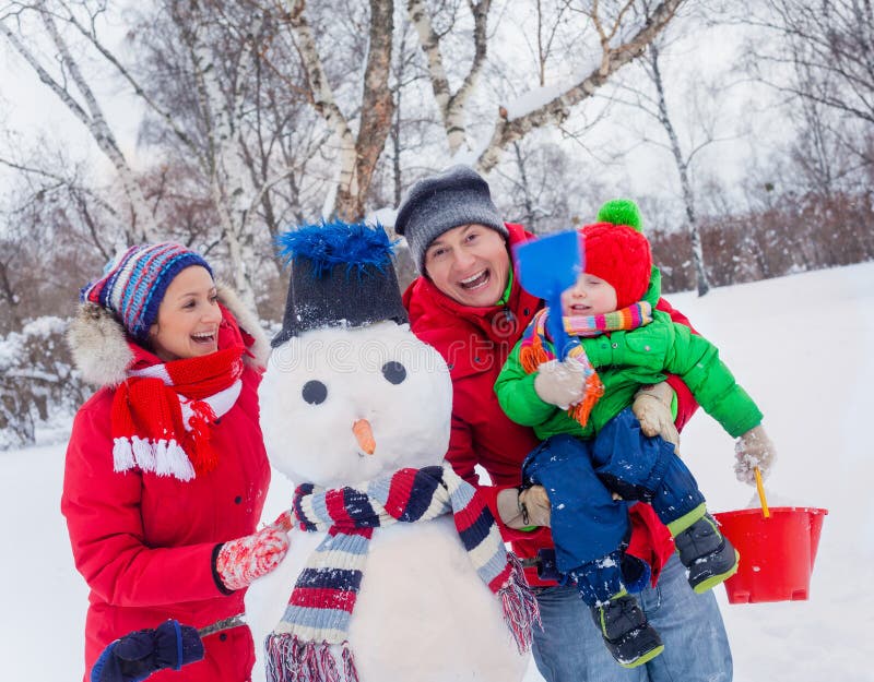 Family with a snowman stock photo. Image of holiday, clothing - 63757332